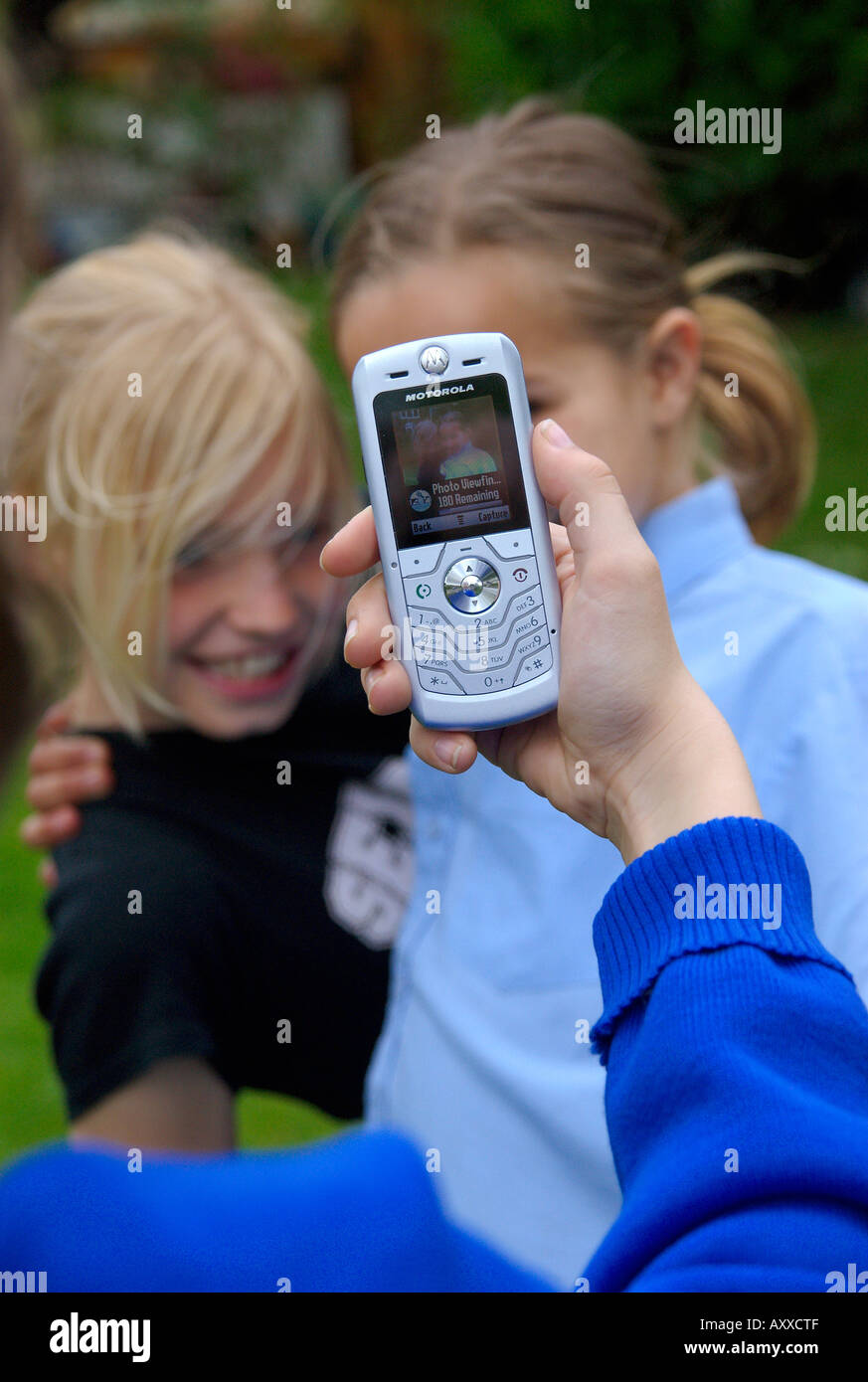 young girls smiling cheekily photographed by mobile phone camera Stock ...