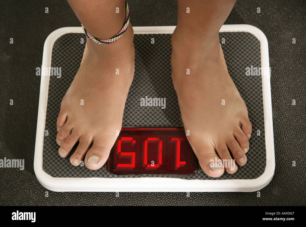Female's feet on a scale measures 105 pounds Stock Photo - Alamy