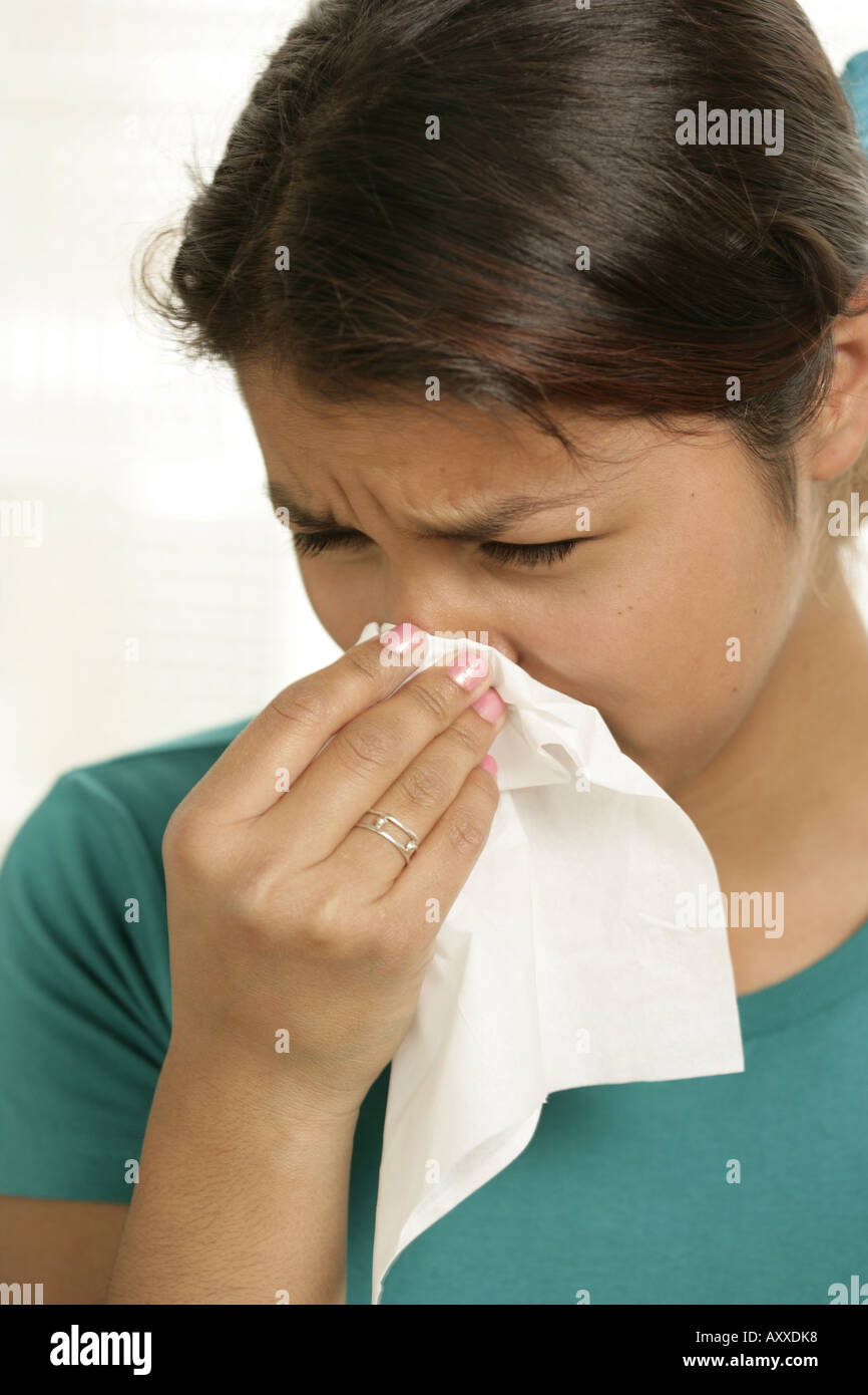 Woman uses tissue to blow her nose Stock Photo - Alamy