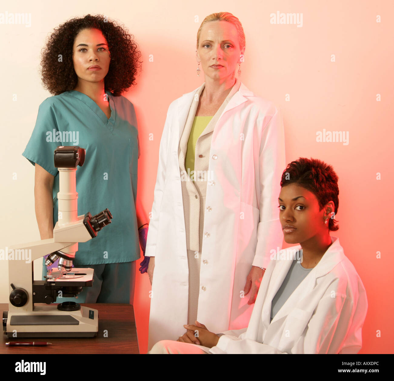 Research team pose with microscope Stock Photo - Alamy