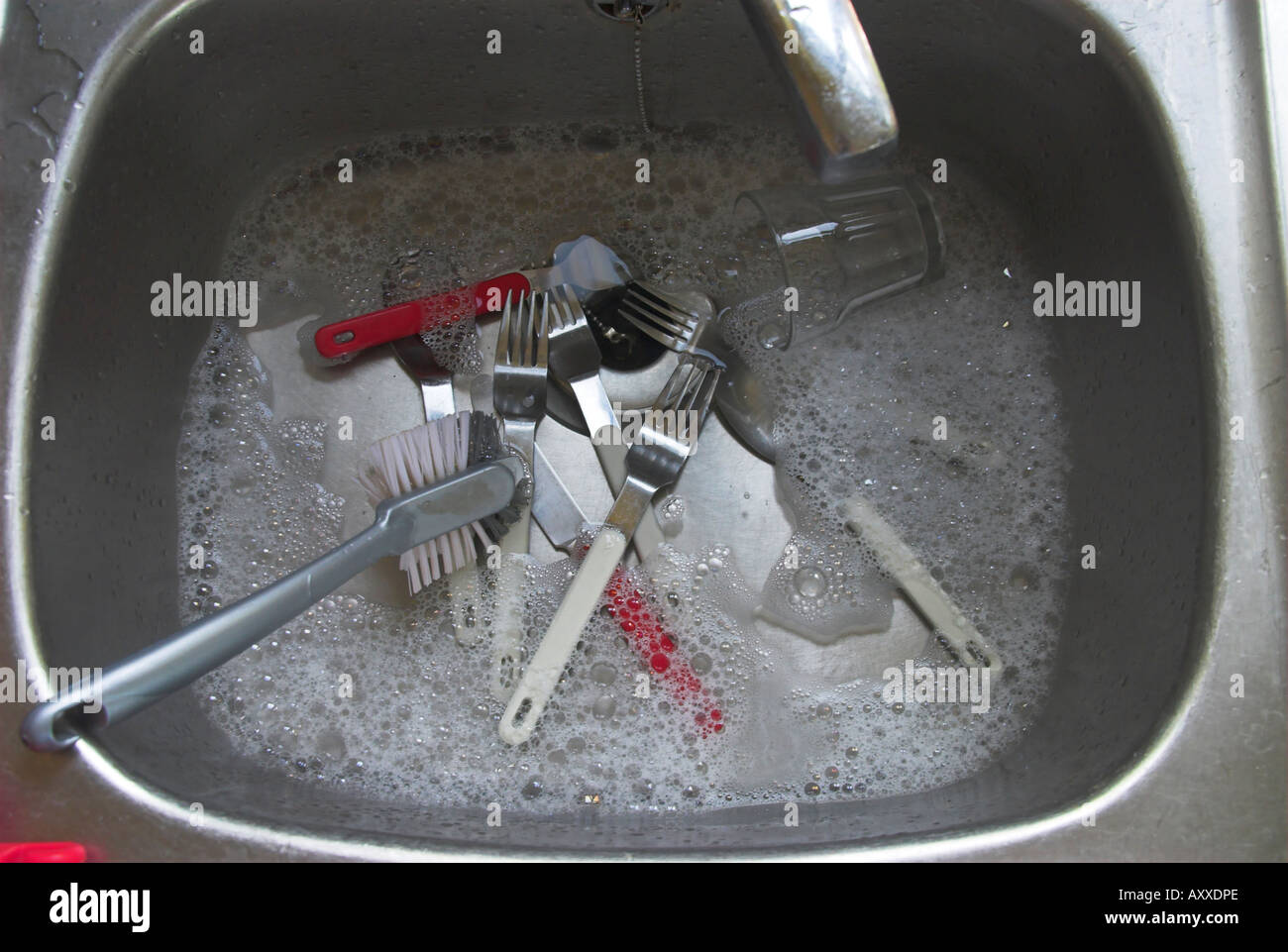 washing up bowl with utensils Stock Photo - Alamy