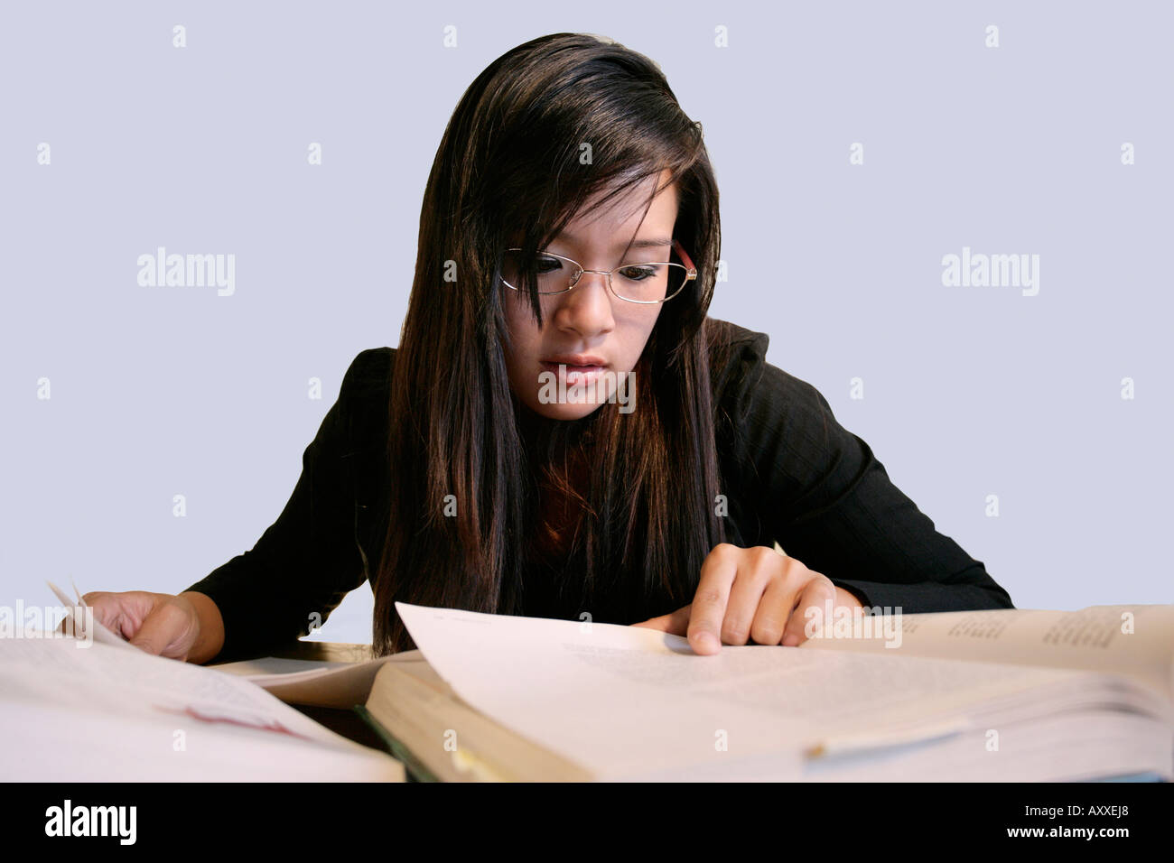 Young female student reading and taking notes Stock Photo - Alamy