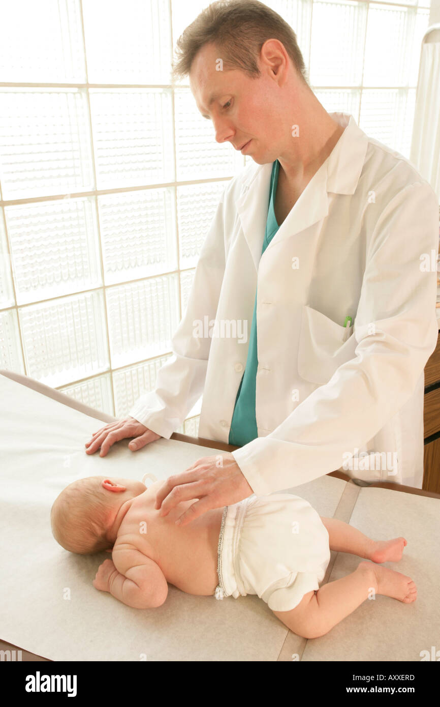 Pediatrician performs a physical exam on a little baby Stock Photo - Alamy