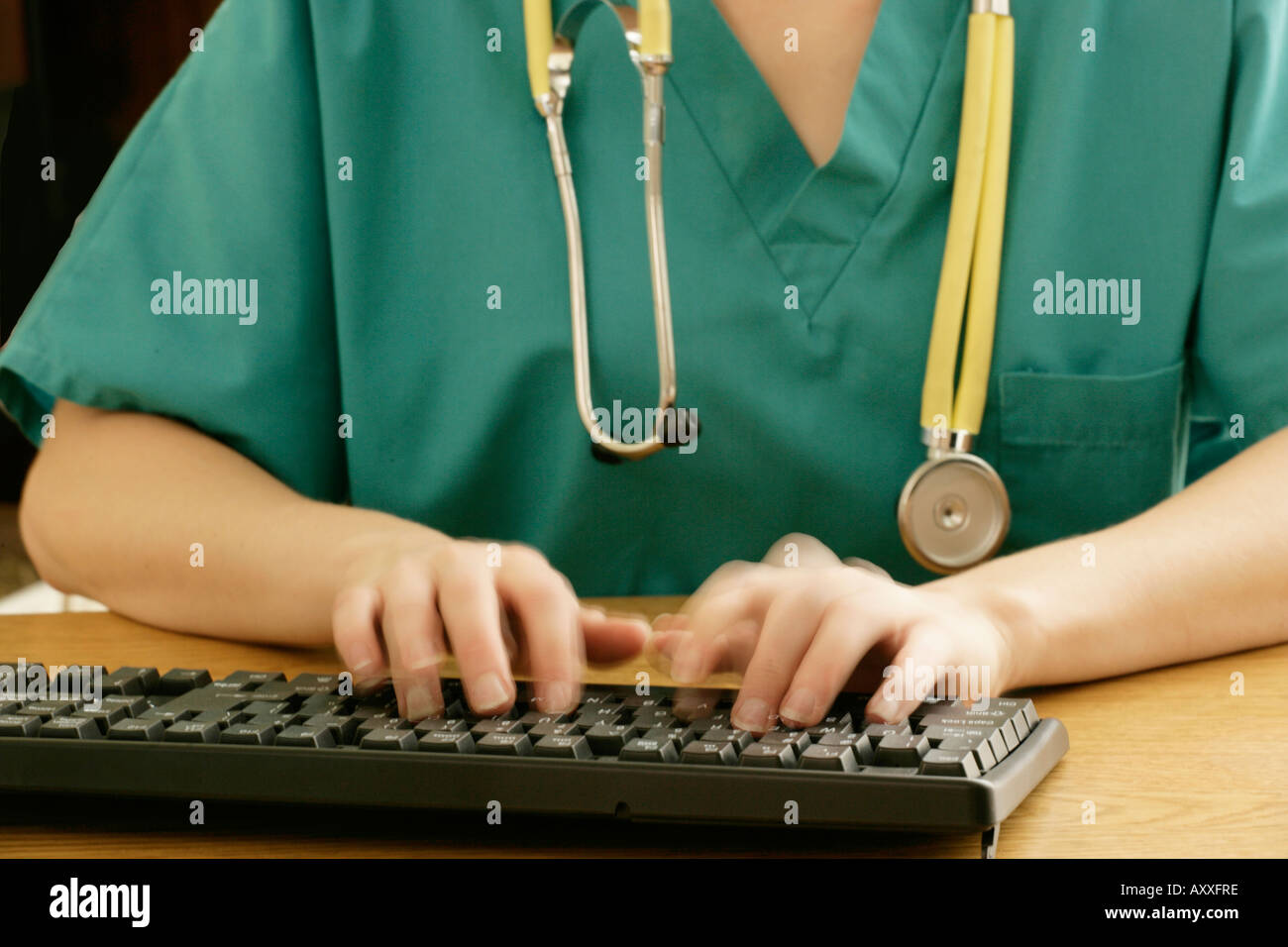 Healthcare nurse types patient record info into hospital, clinic or ...