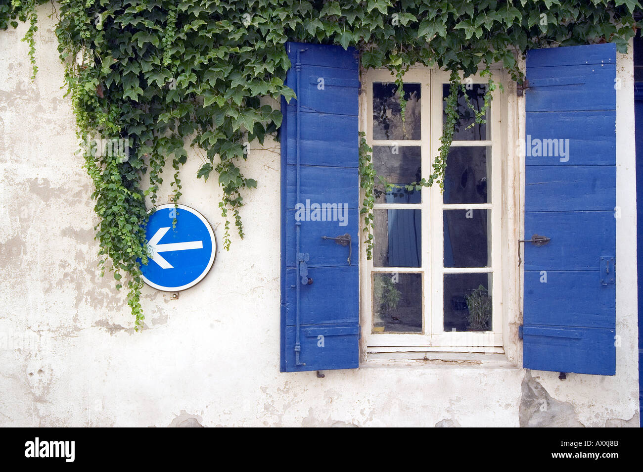 direction arrow sign in a wall of a french house Stock Photo - Alamy
