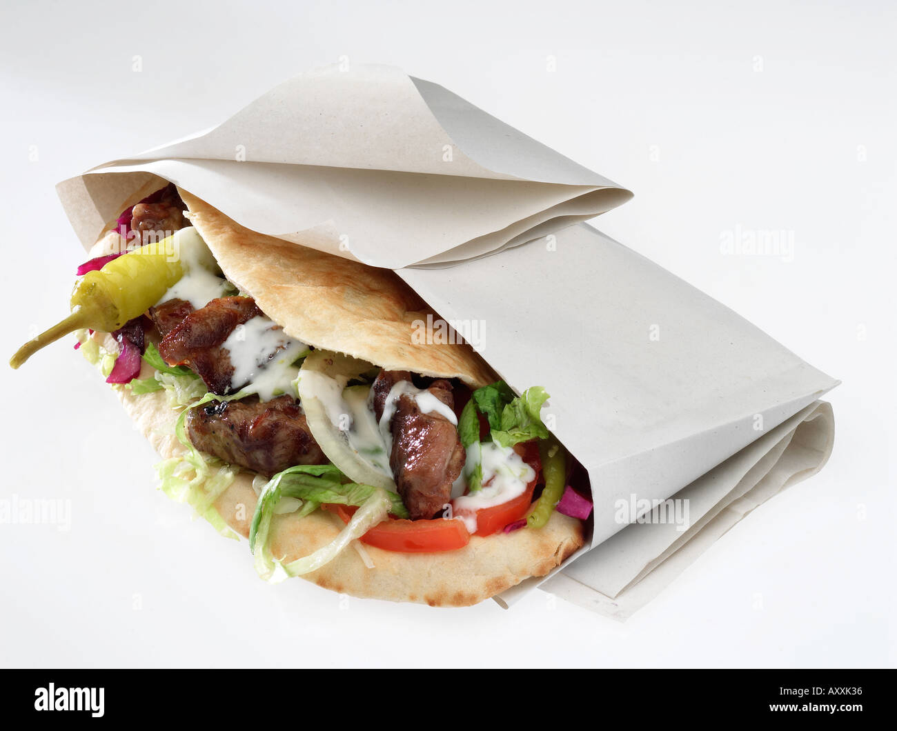 Shish Kebab with salad in pitta bread and paper Stock Photo - Alamy