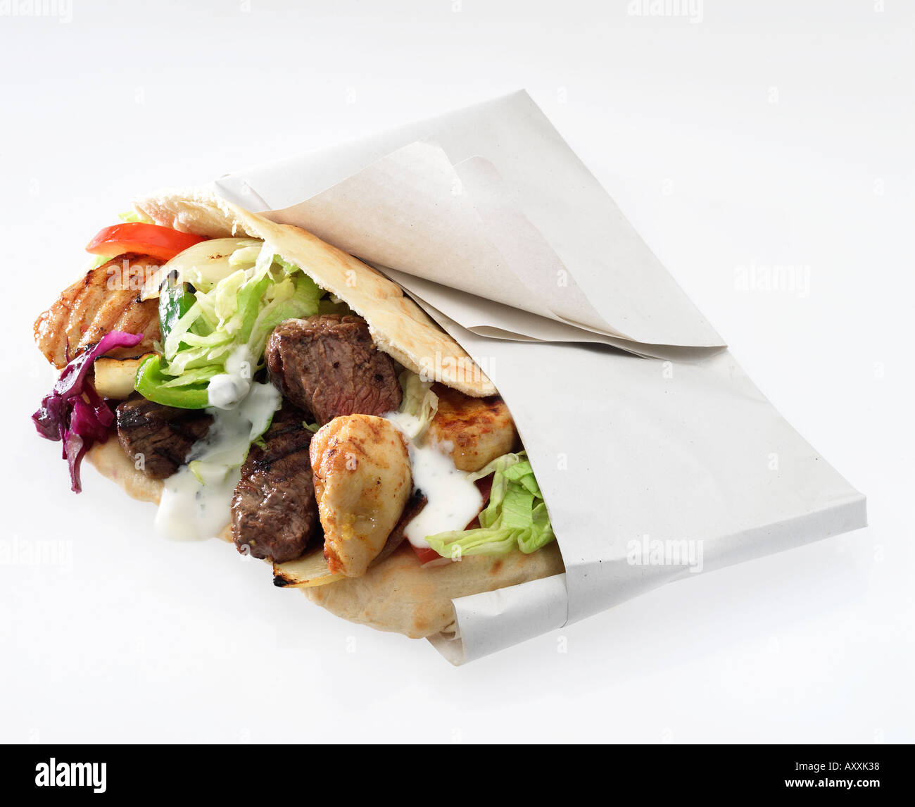 Beef and Chicken kebab with salad in pitta bread in paper Stock Photo ...