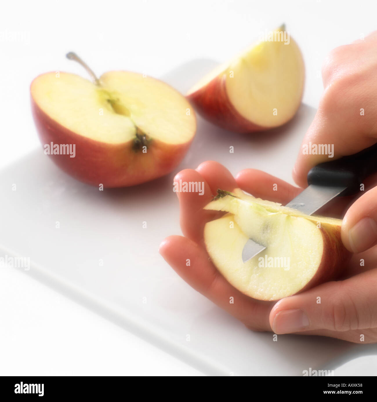 Royal Gala Apple cut in half with quarter being cored Stock Photo - Alamy