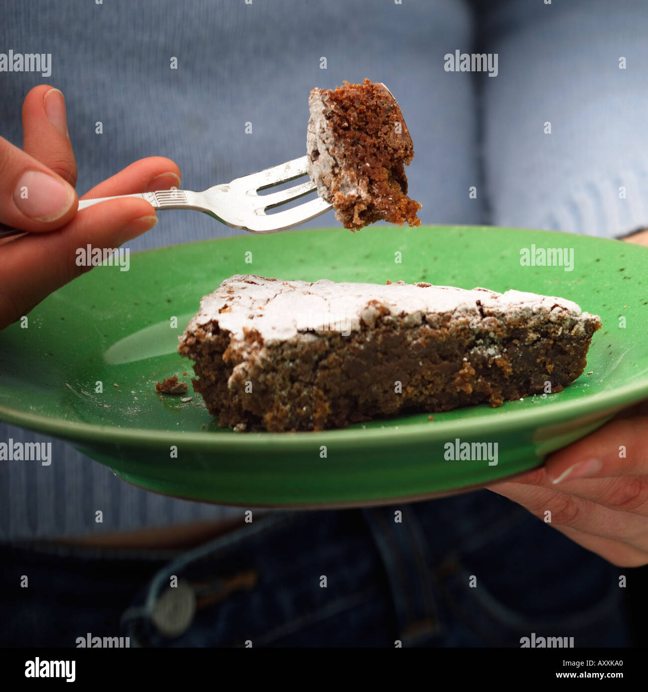 Mocha Fudge Brownie, single slice on plate hand holding portion on fork ...