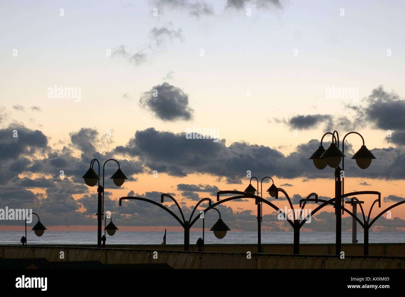 lamp post and sea at sunset Stock Photo - Alamy