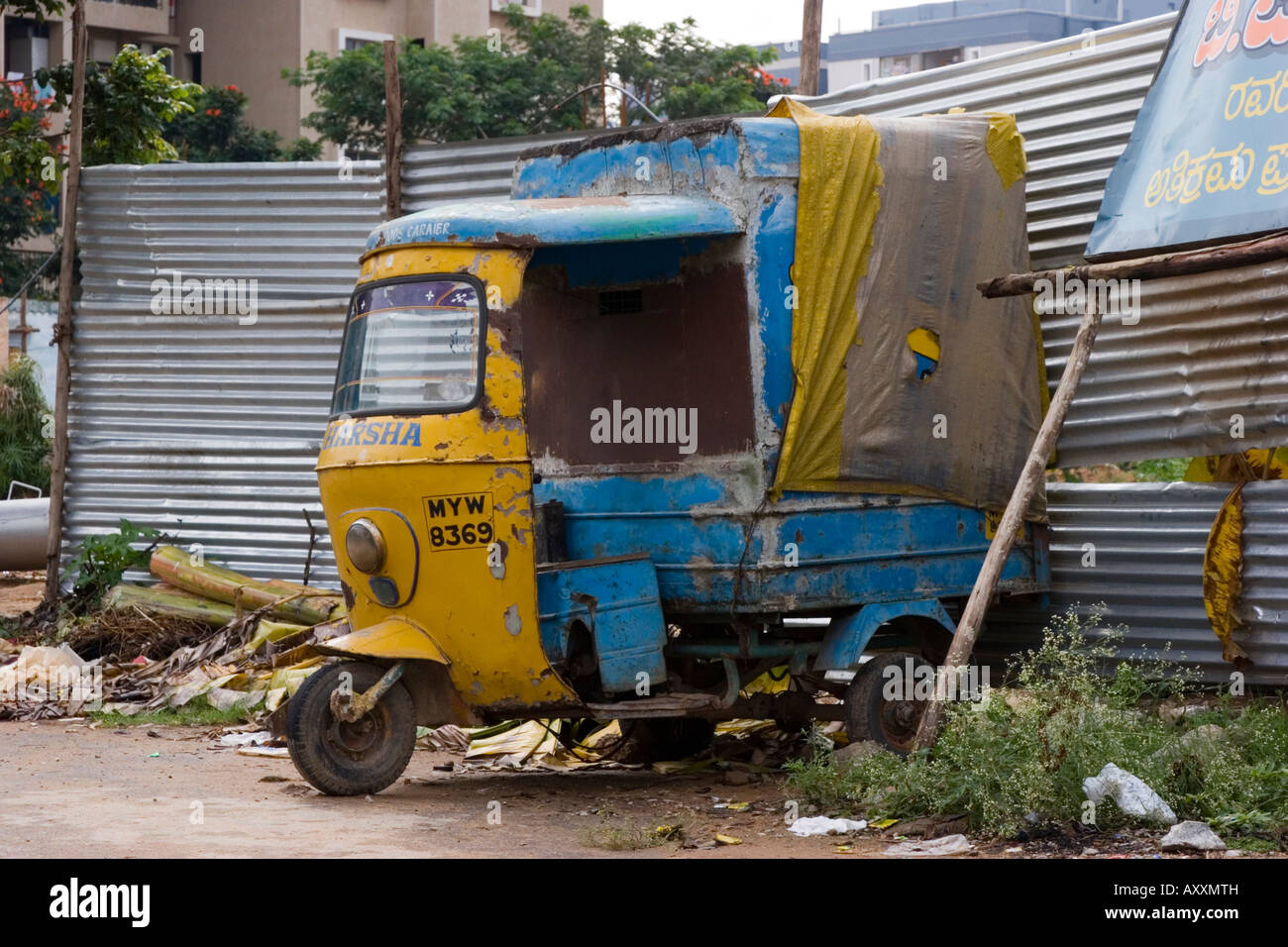 Neglected and tatty auto rickshaw parked by the side of the road in ...
