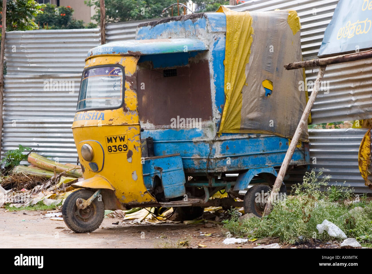 Neglected and tatty auto rickshaw parked by the side of the road in ...
