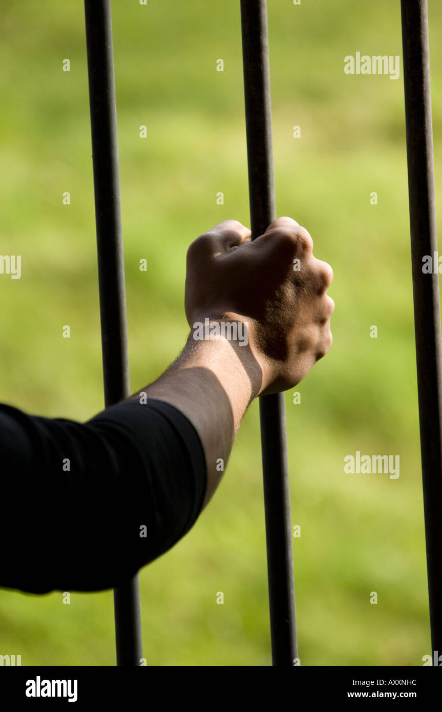 hand grabbing bars Stock Photo - Alamy
