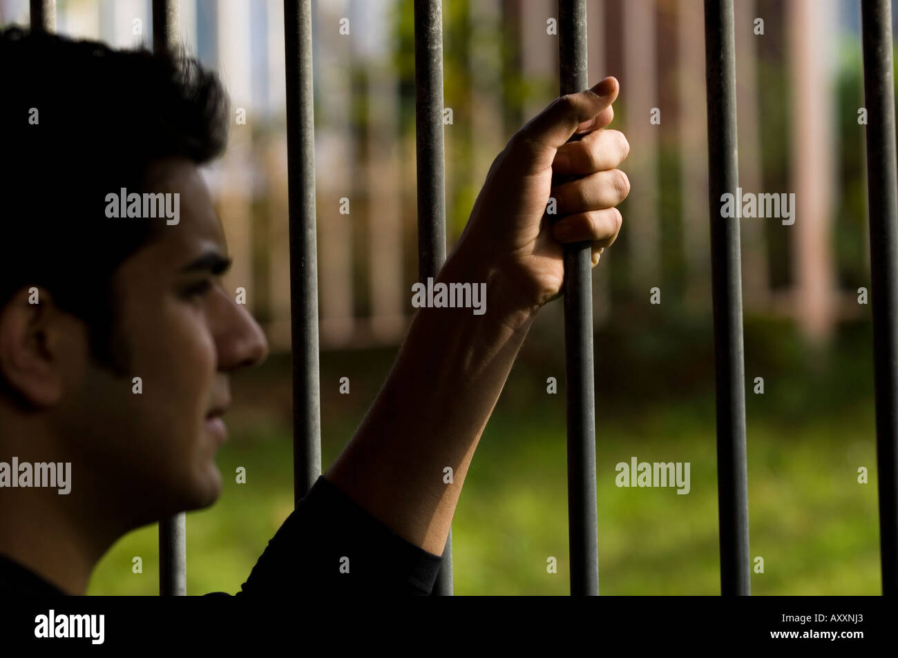 man behind bars Stock Photo - Alamy