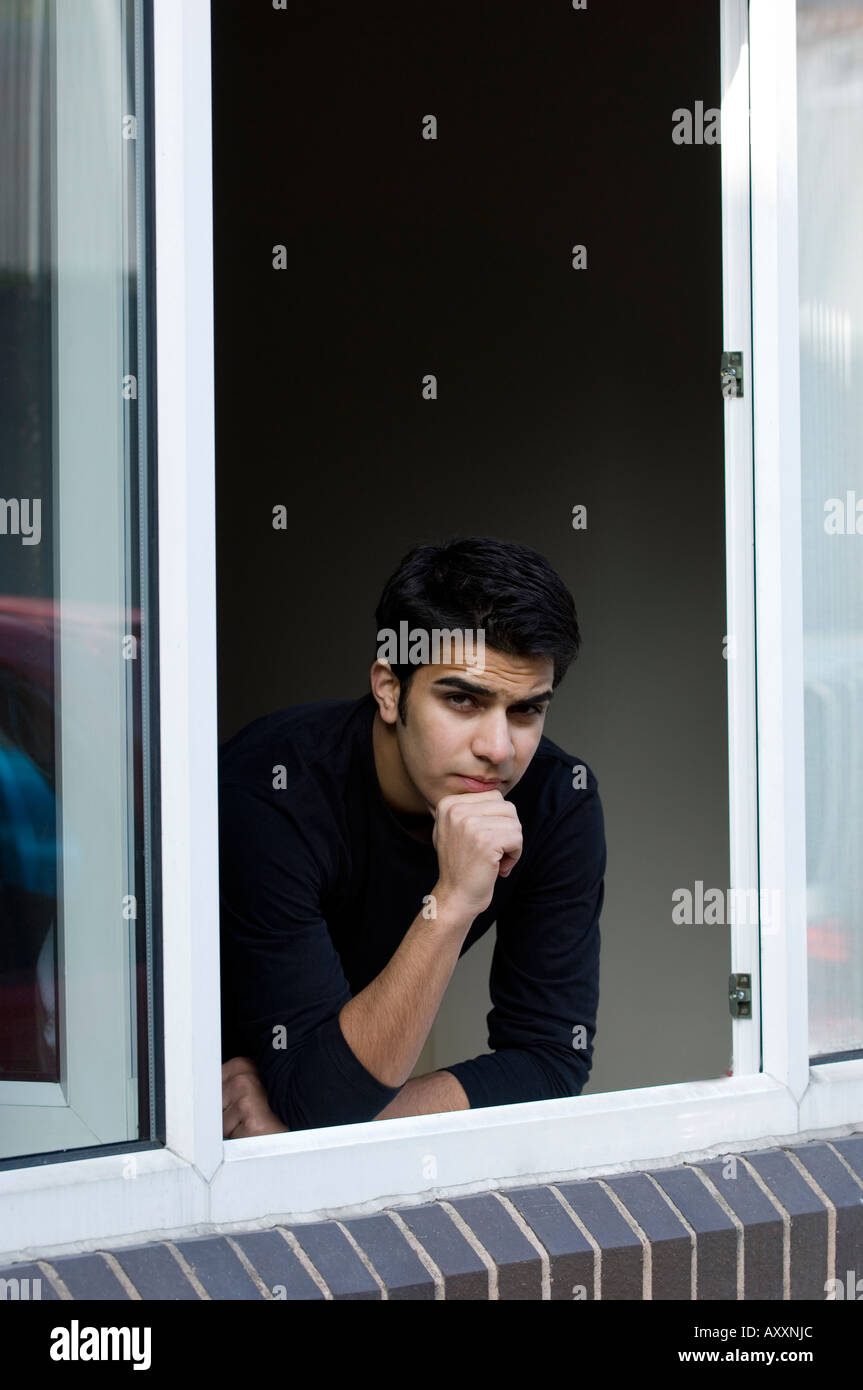 Young Pakistani Asian teenage man looking out of window Stock Photo - Alamy