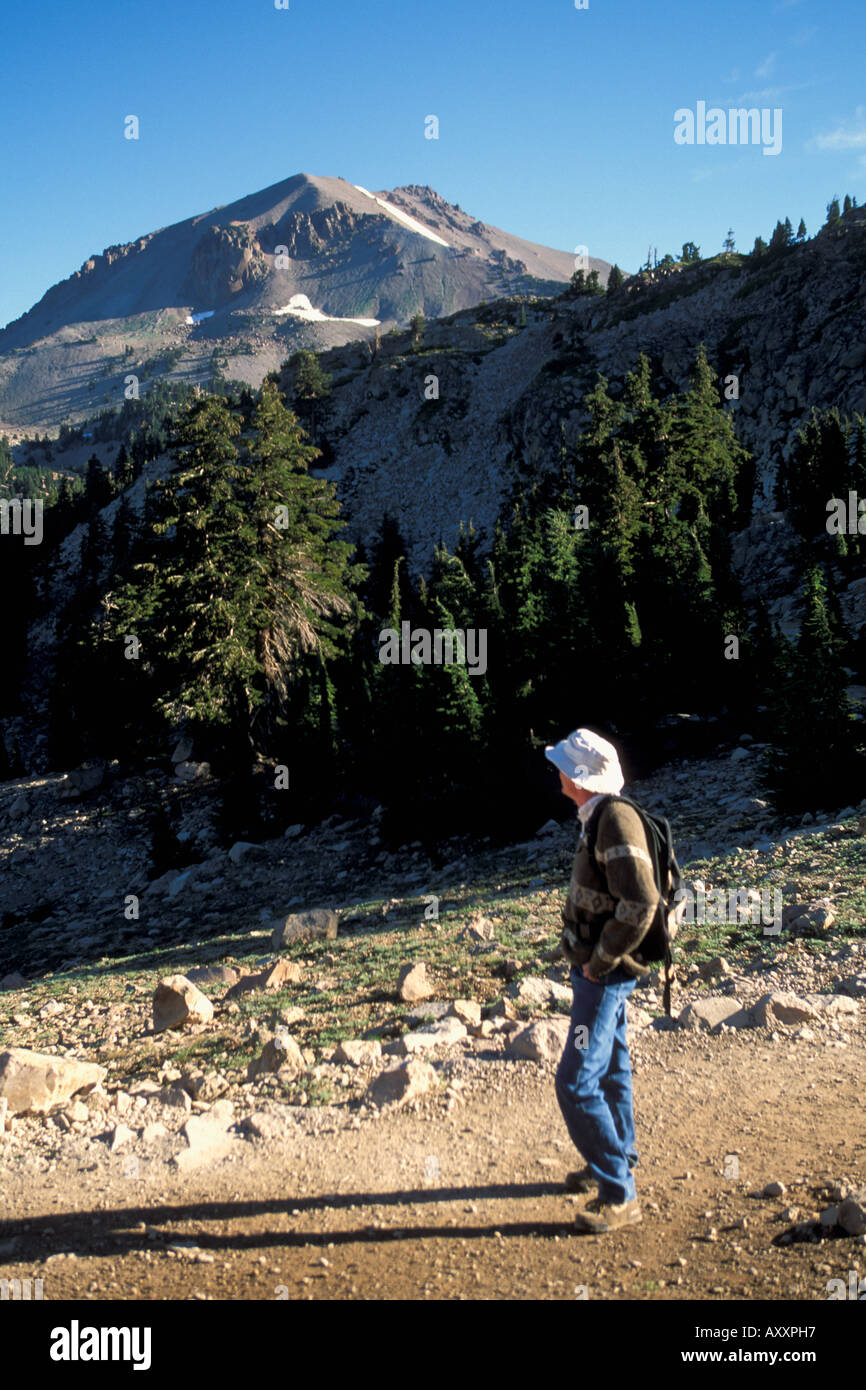 Hiker on trail to Bumpass Hell below Mount Lassen volcano peak Lassen ...