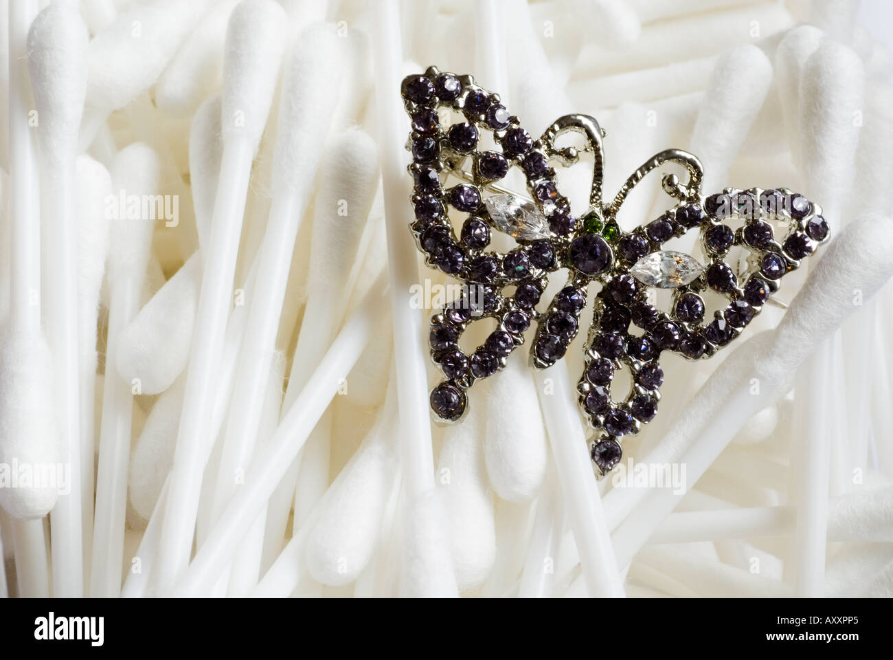 butterfly charm on white cotton swabs Stock Photo - Alamy