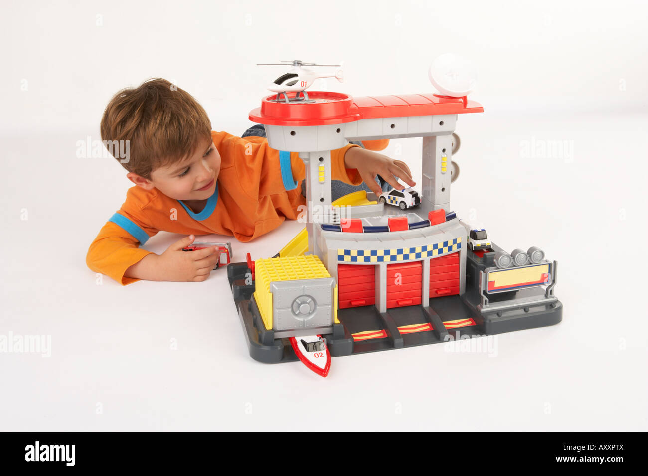 a boy plays with a toy emergency centre station Stock Photo - Alamy