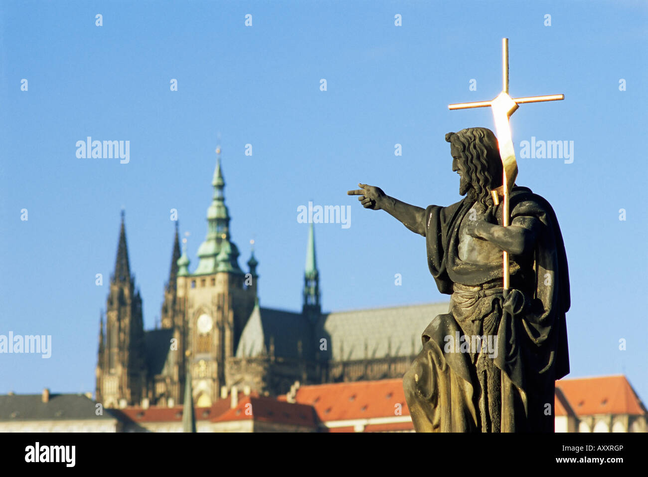 Statue of St. John the Baptist, pointing to Gothic St. Vitus Cathedral ...