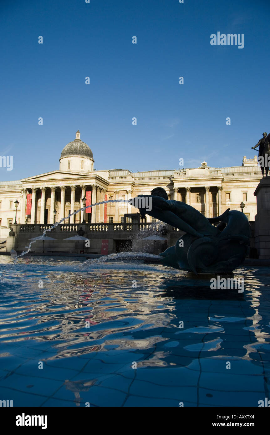 Fountains in Trafalgar Square with the National Gallery in sunlight ...