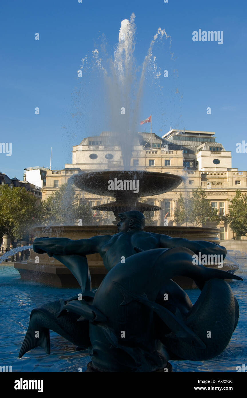 Fountains and mermaids in Trafalgar Square central London under a blue ...