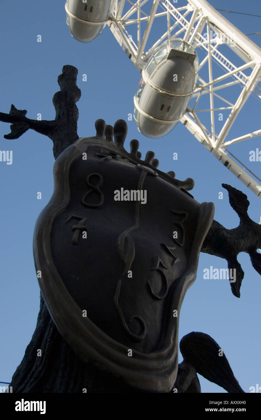 Dali sculpture of melting clock with the London Eye behind against a ...