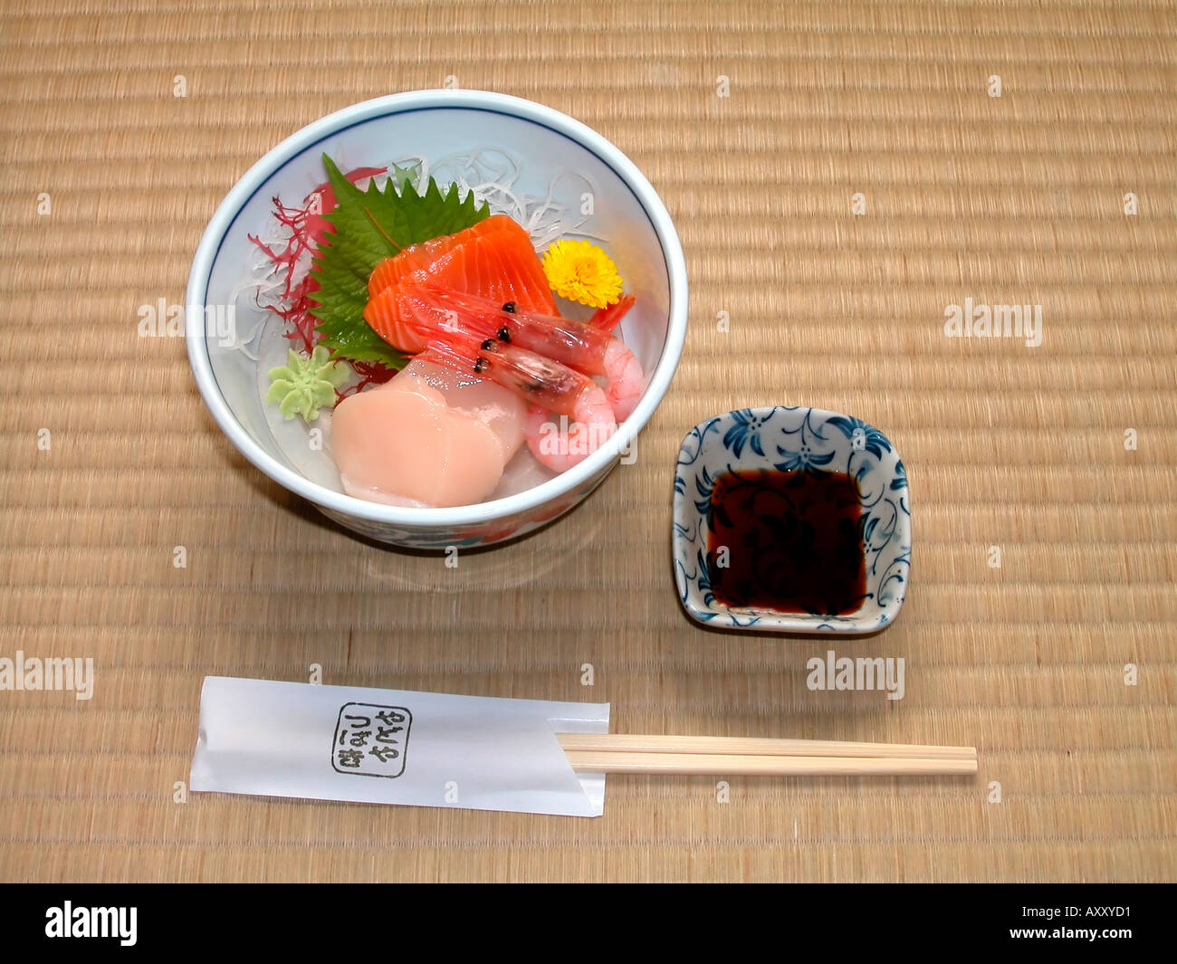 Japanese Sashimi slices of raw fish or seafood on a bed of shredded ...