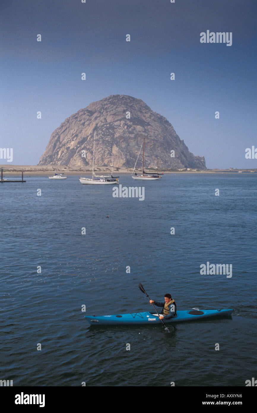 Kayaker kayaking in kayak in front of Morro Rock Morro Bay California ...