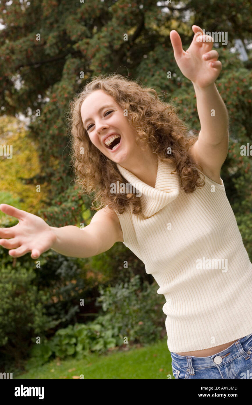 Young girl with arms outstretched Stock Photo - Alamy