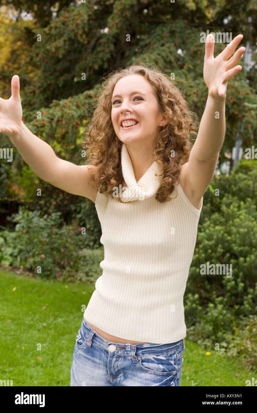 Young girl with arms outstretched Stock Photo - Alamy