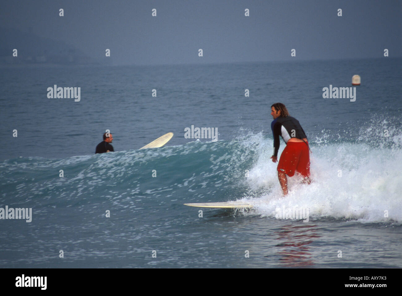 Surfer riding surfboard on waves at Surfrider Beach State Park Malibu ...