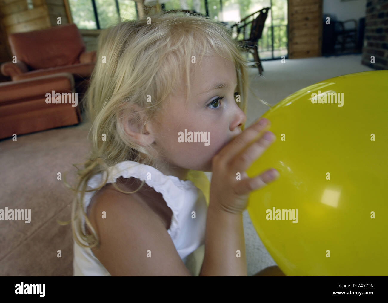 Child blowing up a balloon Stock Photo - Alamy