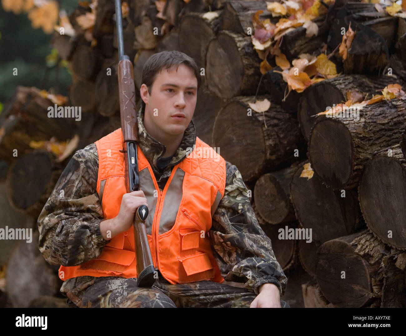 Hunter sitting on a log Stock Photo - Alamy