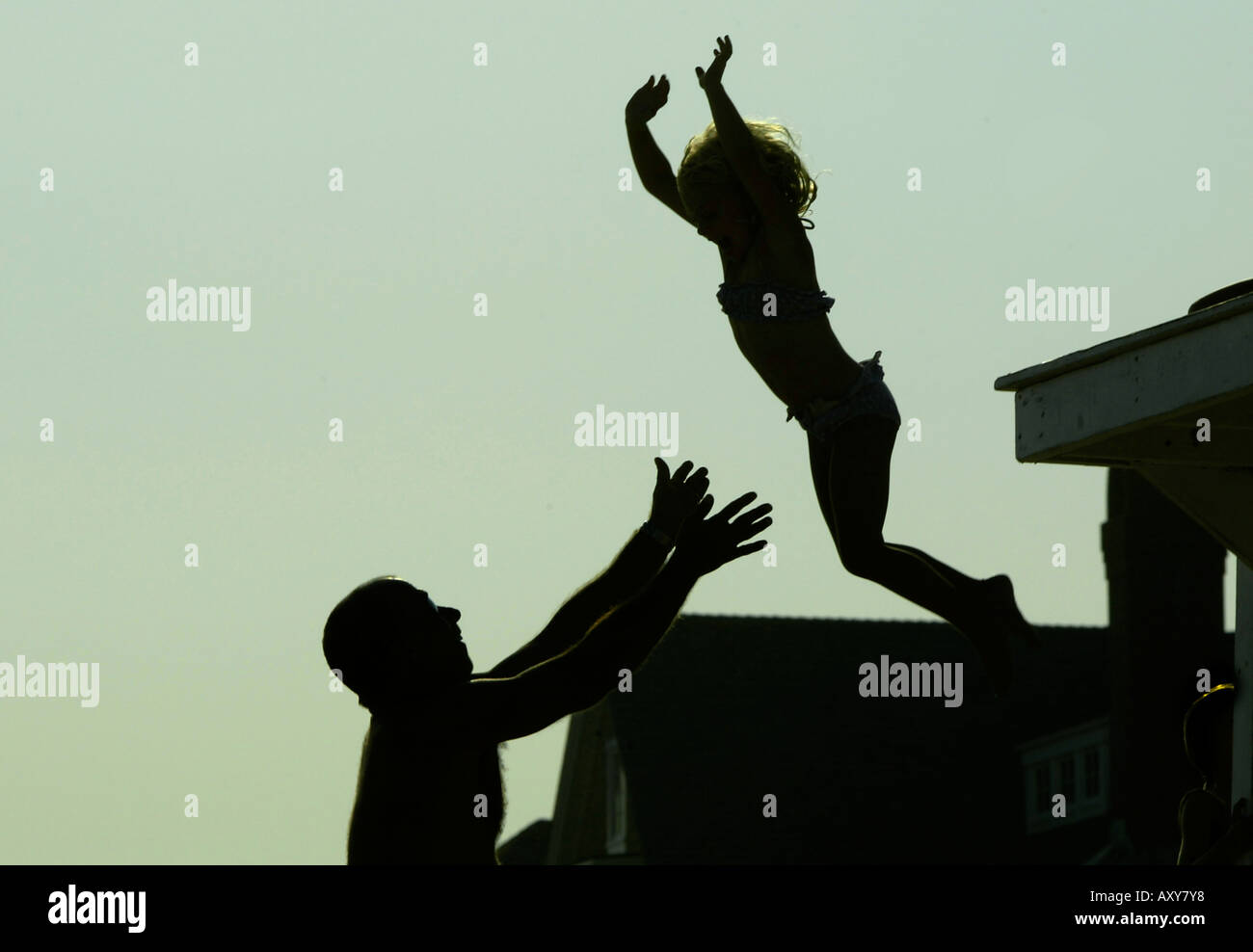 Child jumping fathers arms hi-res stock photography and images - Alamy