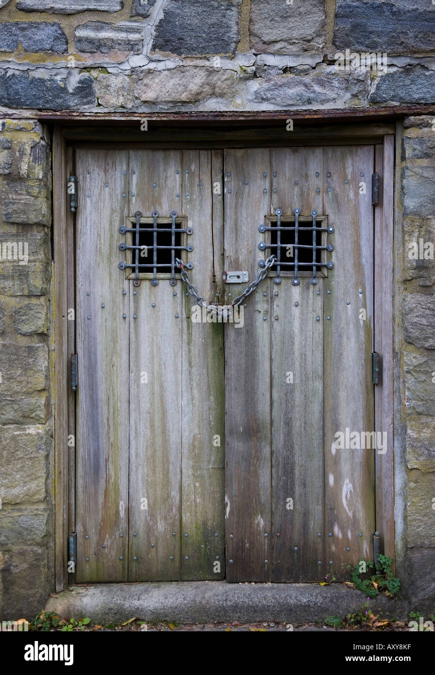 Rustic doors secured by a lock and chain Stock Photo - Alamy
