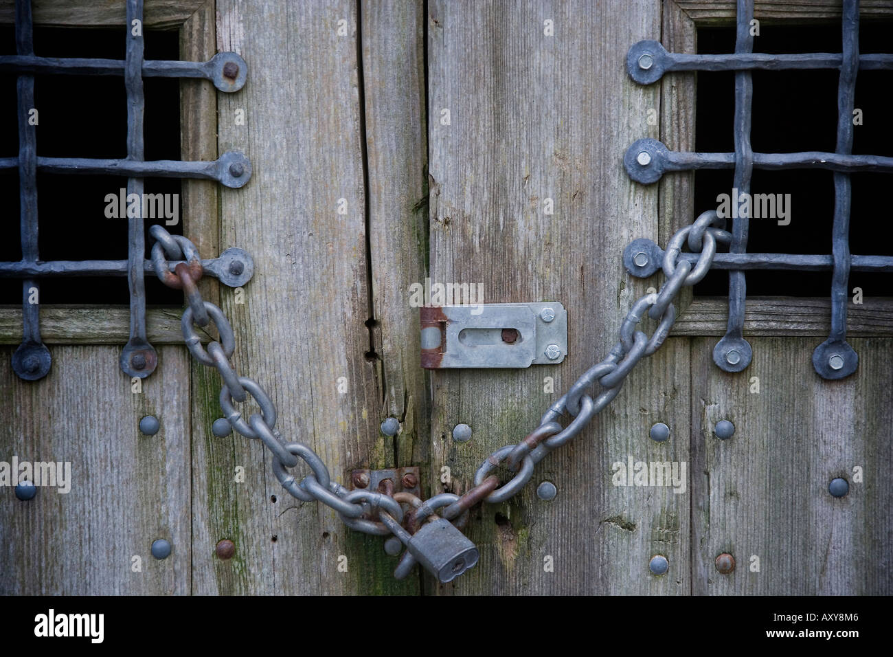 Lock and chain on a rustic window Stock Photo - Alamy
