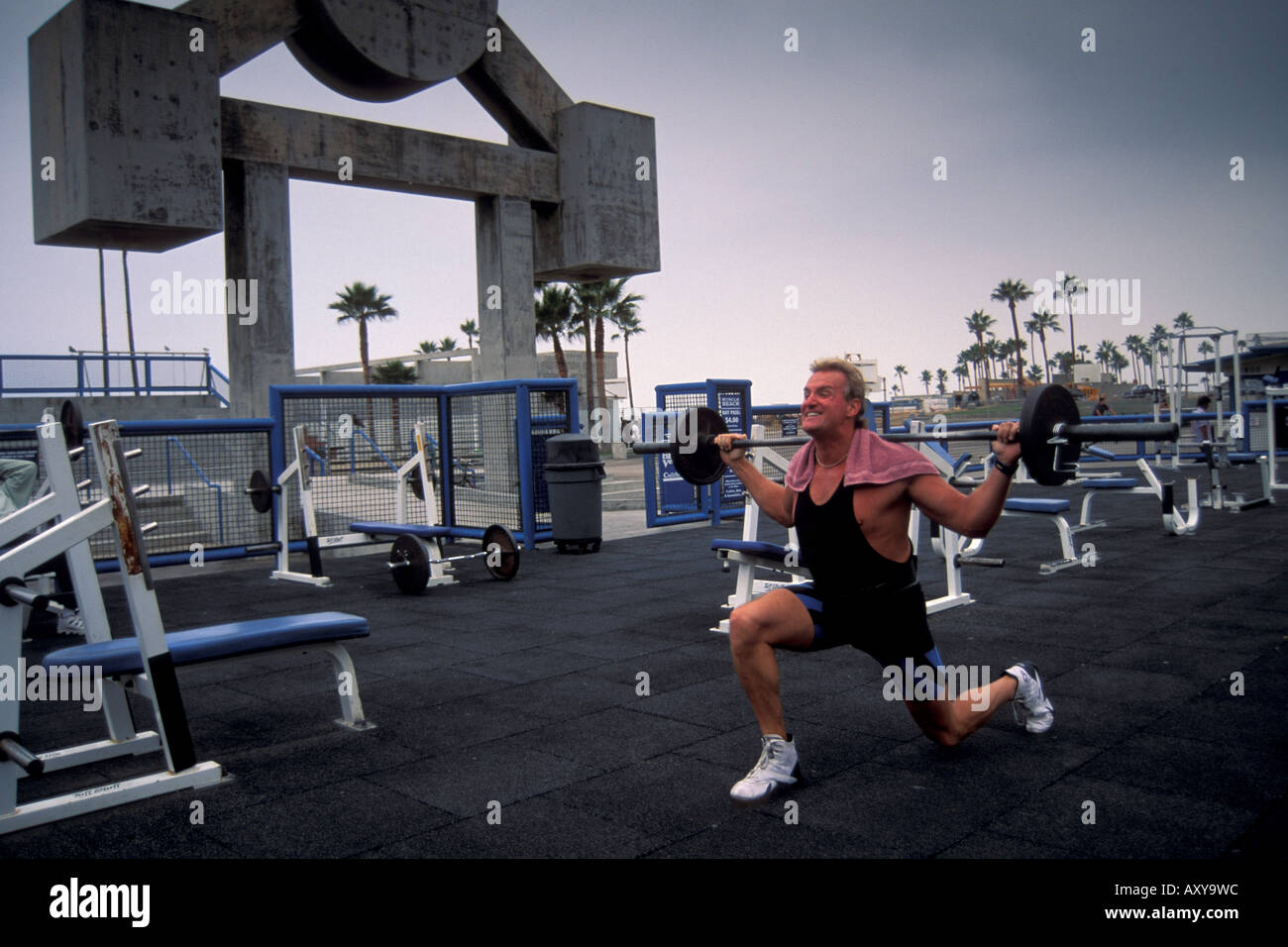 Athletic man working out lifting weight barbell at outdoor gym Muscle ...