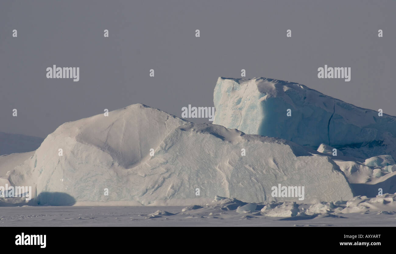 An iceberg frozen into the sea outside of Uummannaq, North Greenland ...