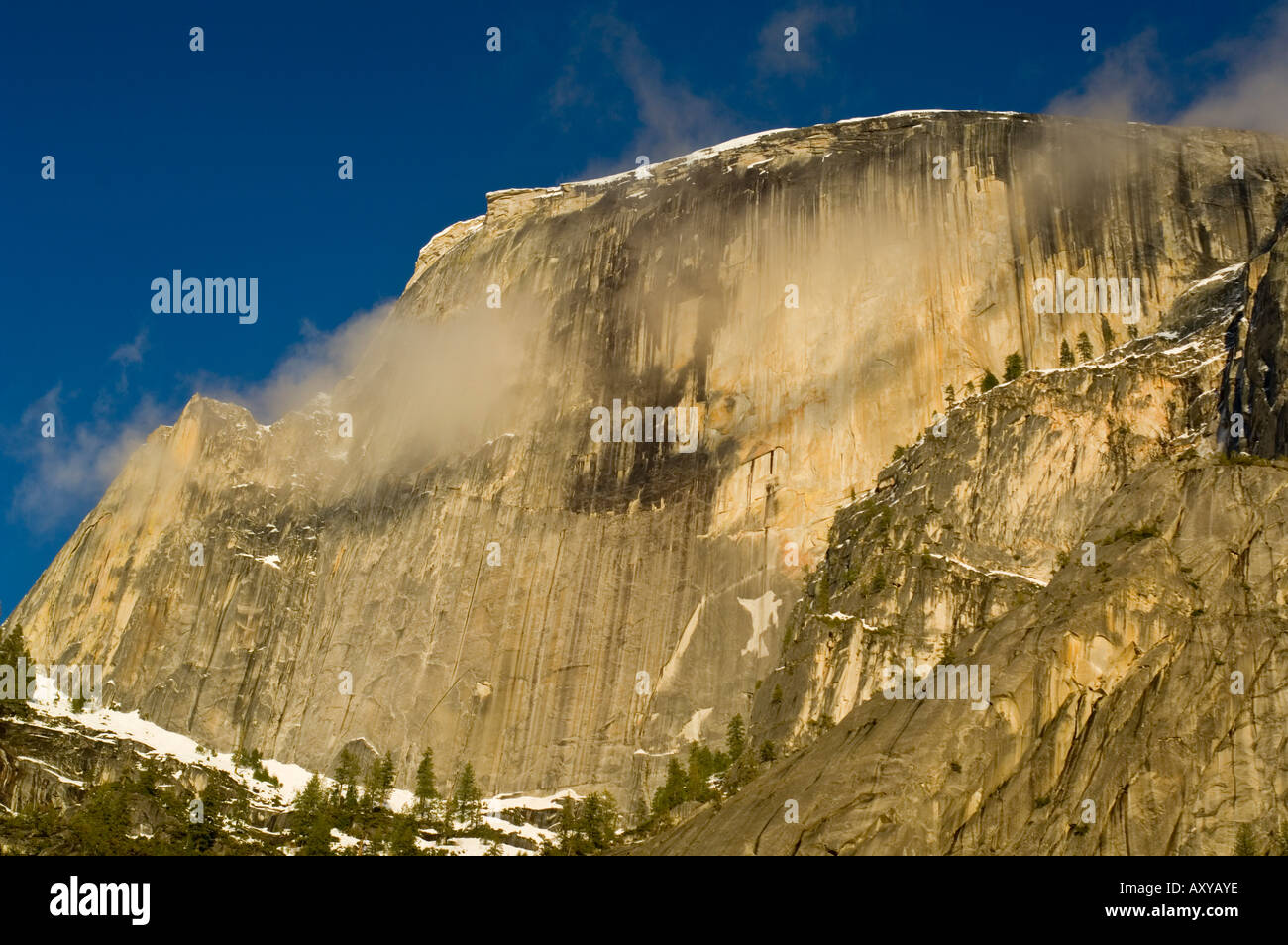 Cloud forming against the huge granite rock cliff face of Half Dome at ...