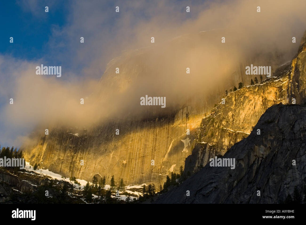 Cloud forming against the huge granite rock cliff face of Half Dome at ...