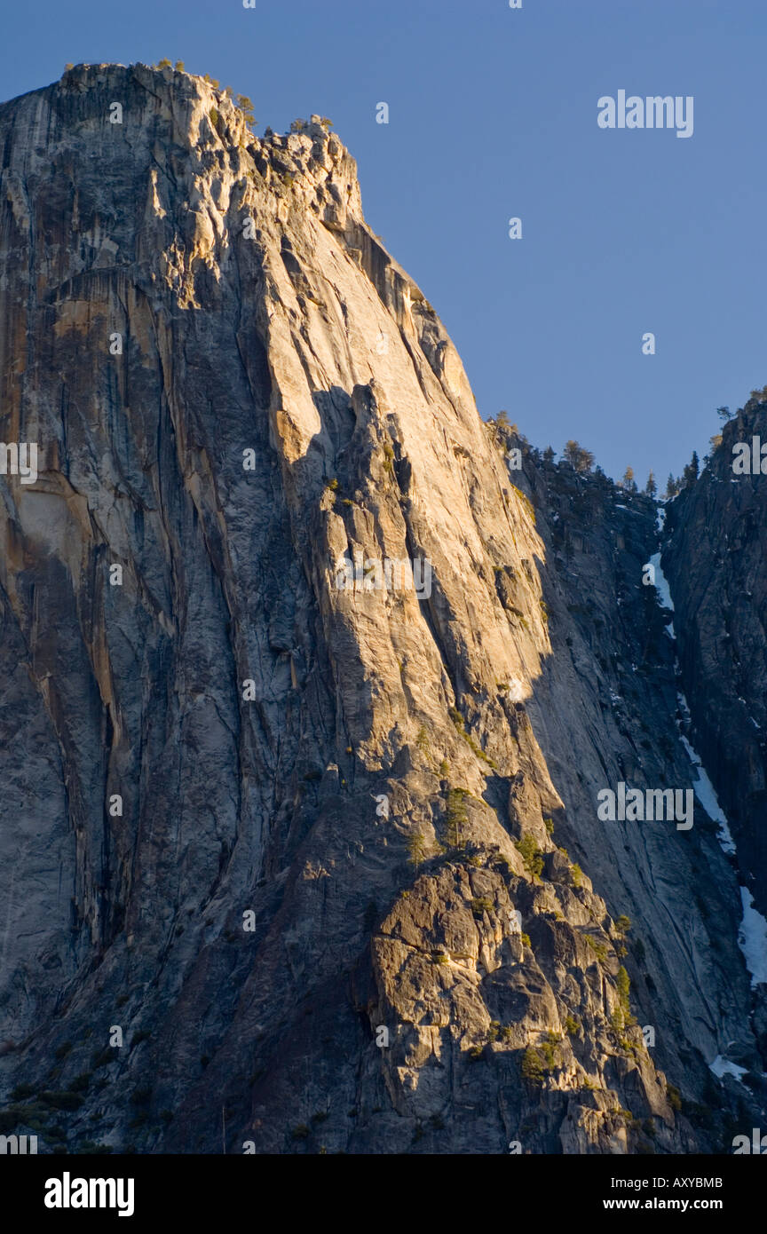 Morning sunlight on steep granite mountain cliffs above Yosemite Valley ...