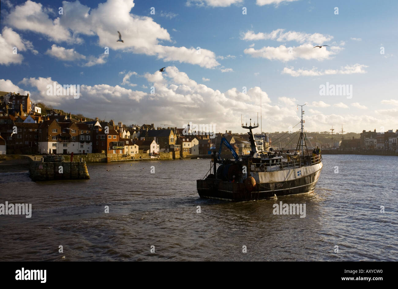 Fishing boat entering Whitby harbour Stock Photo - Alamy