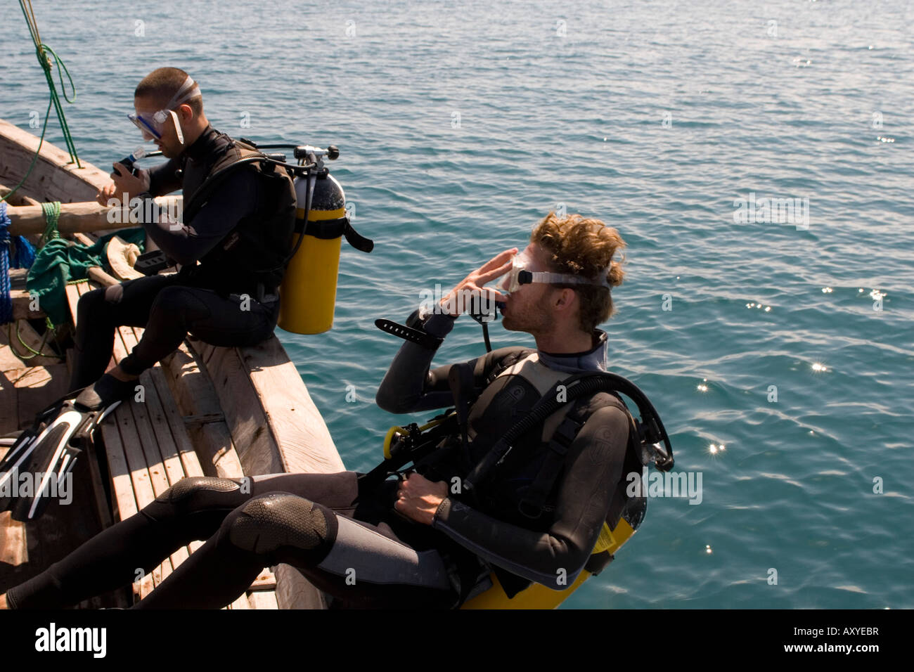 Scuba divers entering water from boat Chole Bay off Mafia Island ...
