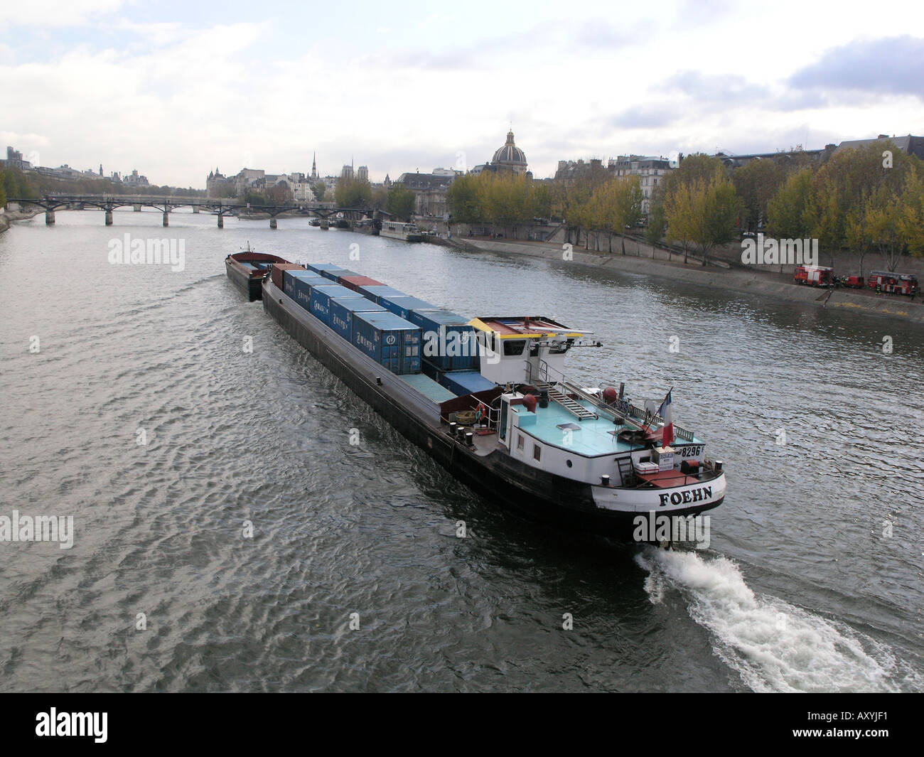 Commercial Container Barge on the River Seine with the Pont des Arts in ...