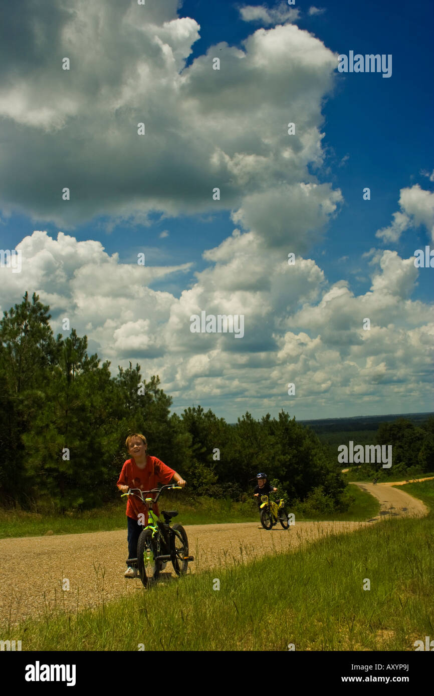 Boy pushing bicycle hi-res stock photography and images - Alamy