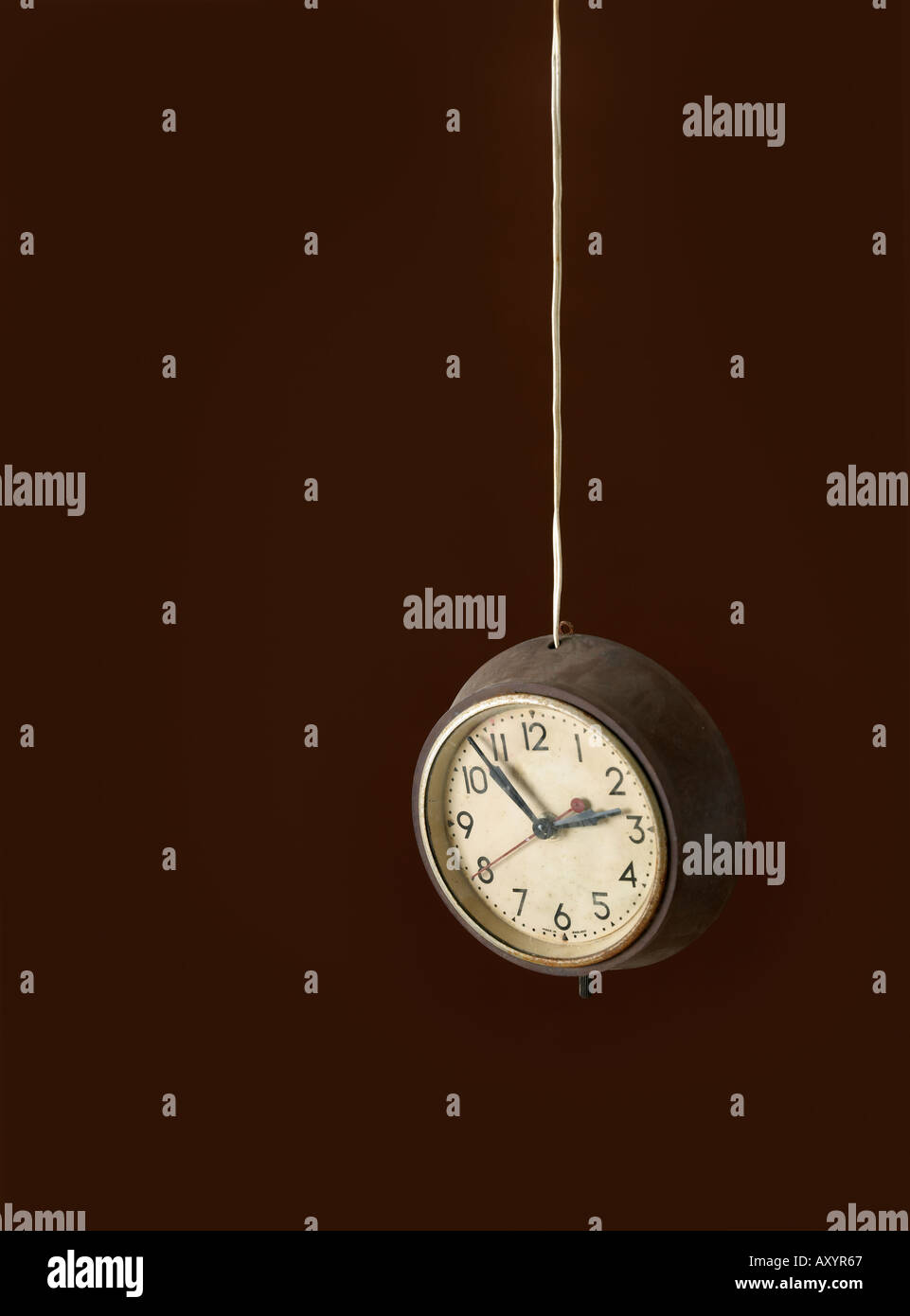 An old clock hanging by its cable Stock Photo - Alamy