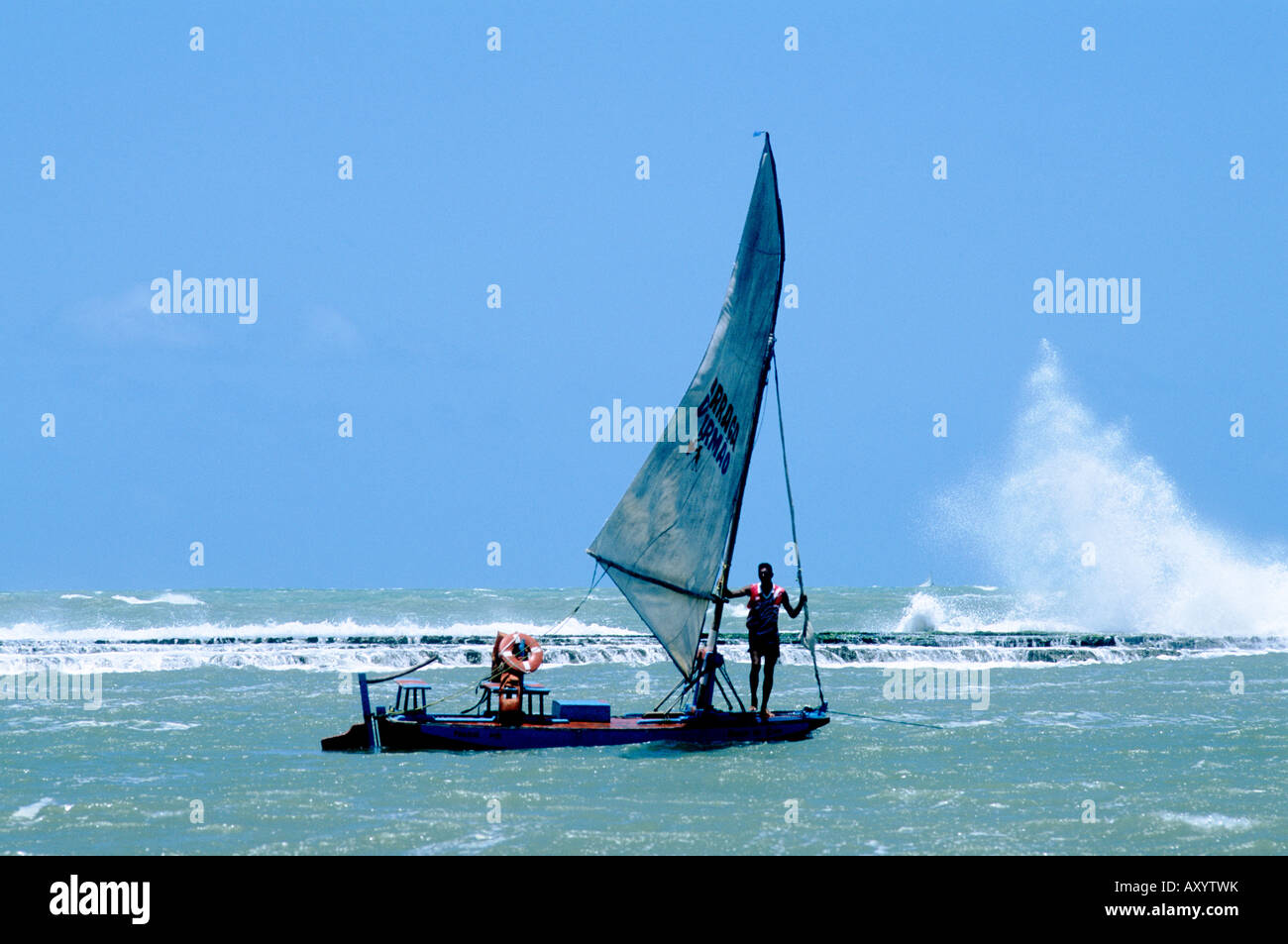 A fisherman anchors his jangada (a traditional sailing boat) in a ...