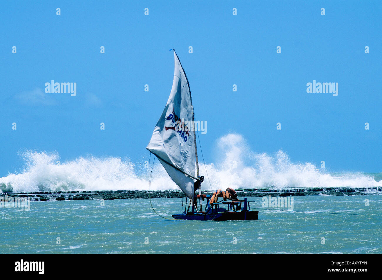 A fisherman anchors his jangada (a traditional sailing boat) in a ...