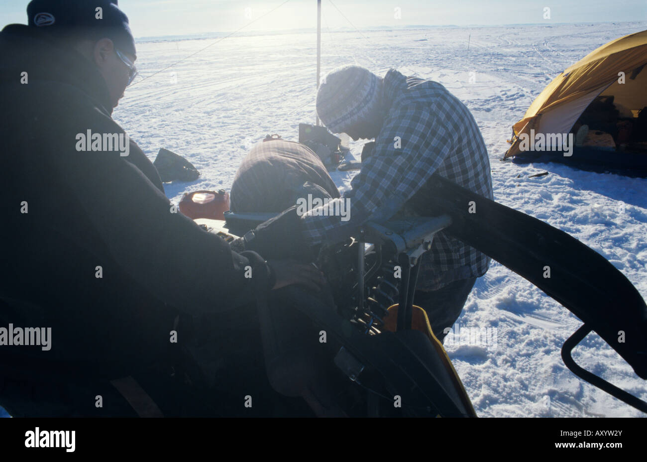 Inuit campers working on a snowmobile Stock Photo - Alamy
