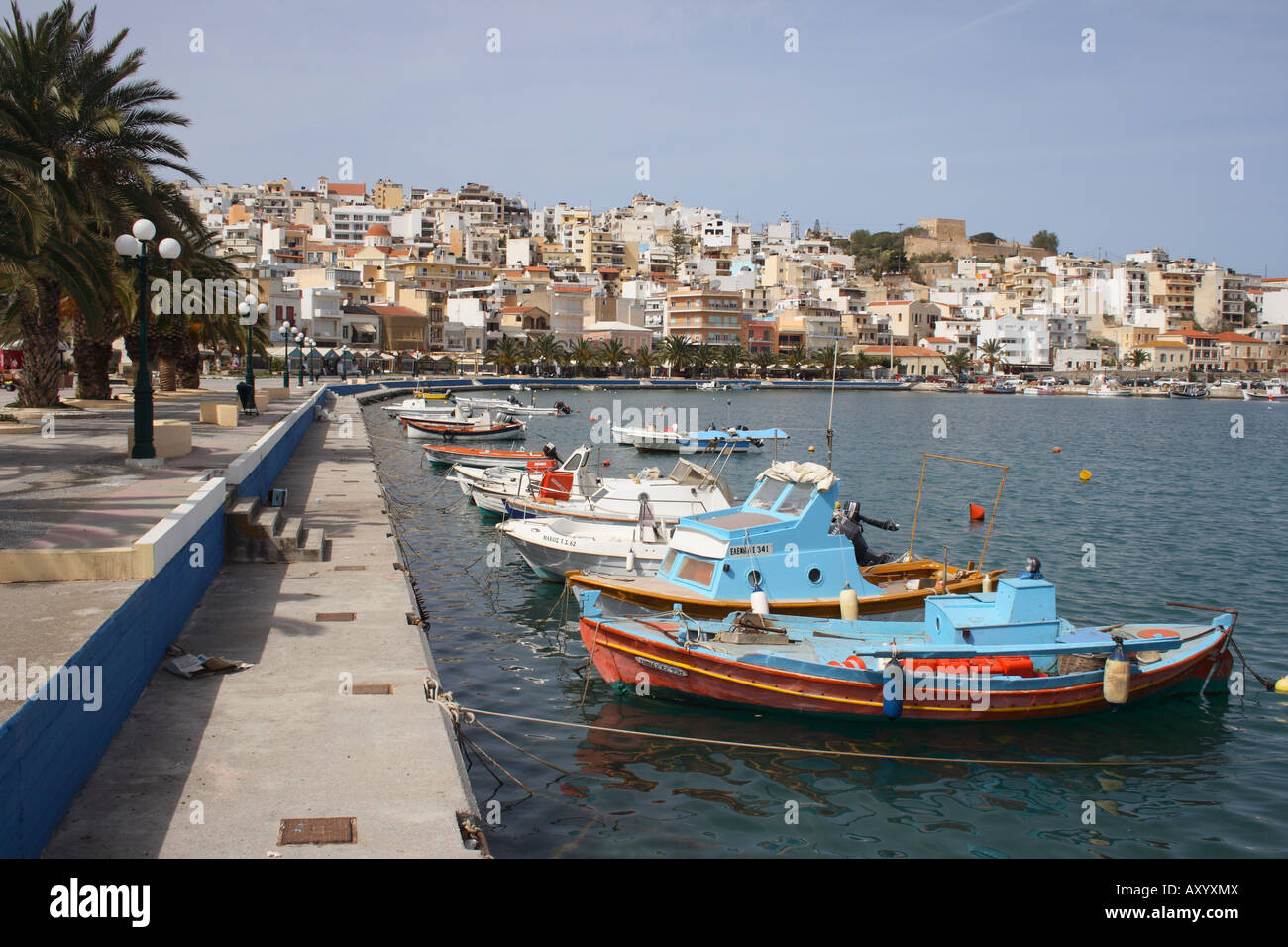 oceanside walk with moored ships at the city of Sitia, Crete, Greece ...